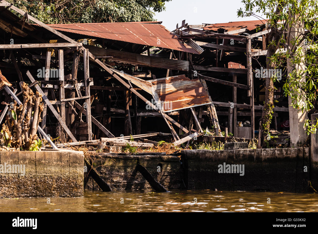 Wooden slums on stilts on the riverside of Chao Praya River in Bangkok ...