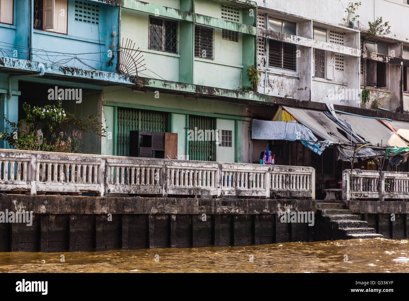 Wooden slums on stilts on the riverside of Chao Praya River in Bangkok ...