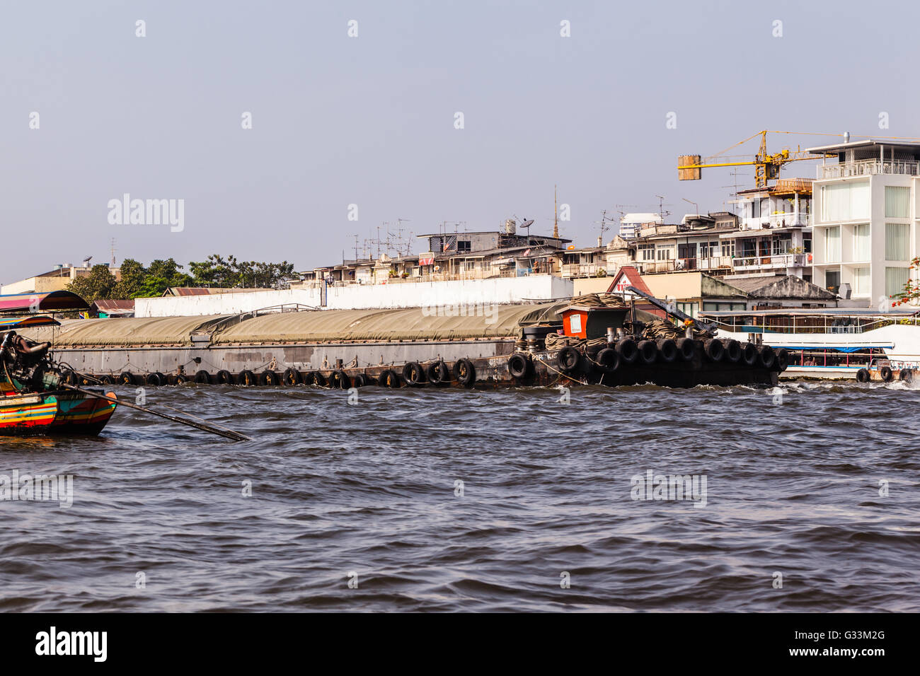 a very big barge floating on Chao Praya River in Bangkok, Thailand ...