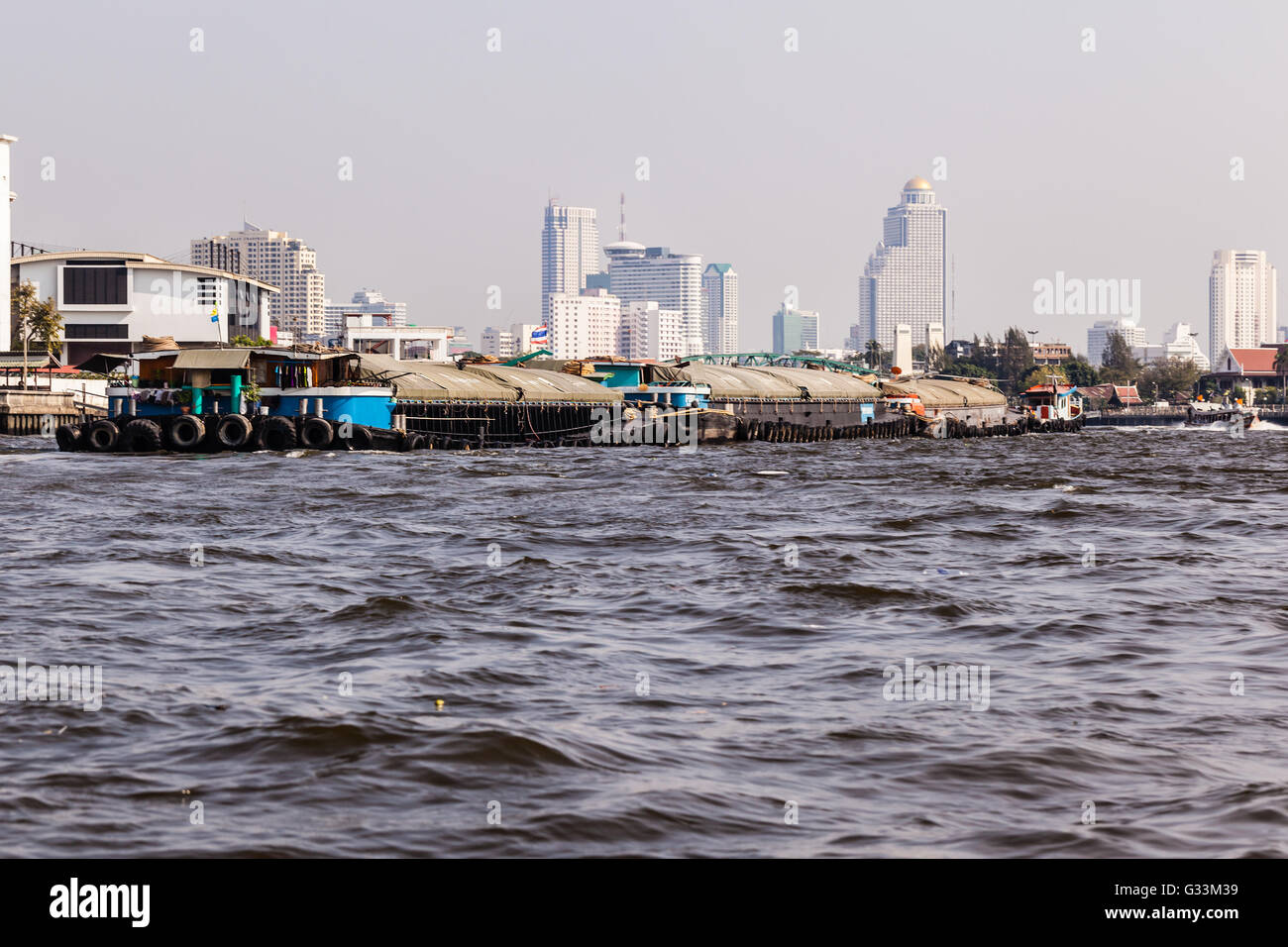 a very big barge floating on Chao Praya River in Bangkok, Thailand ...