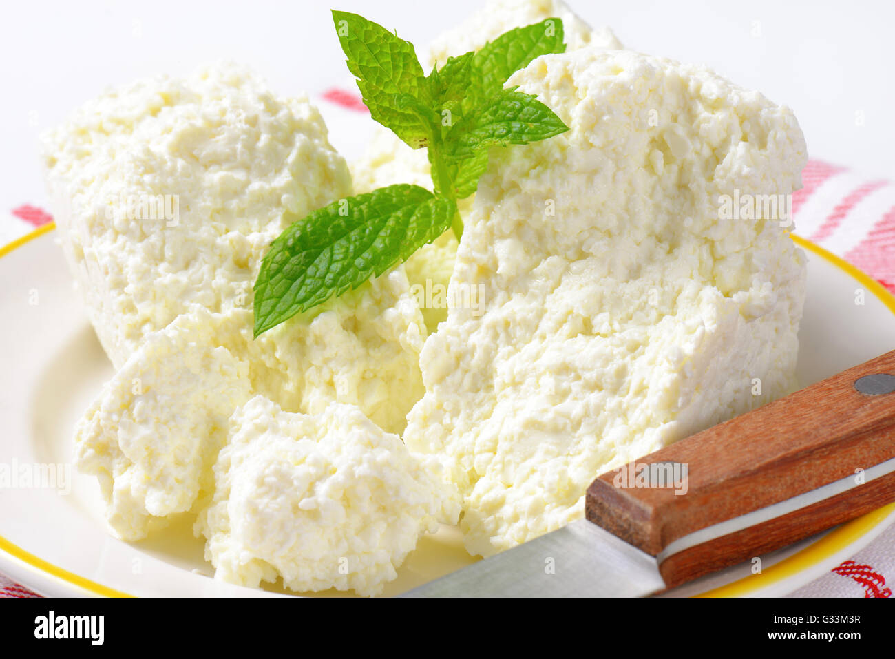 plate of crumbly white cheese - close up Stock Photo - Alamy