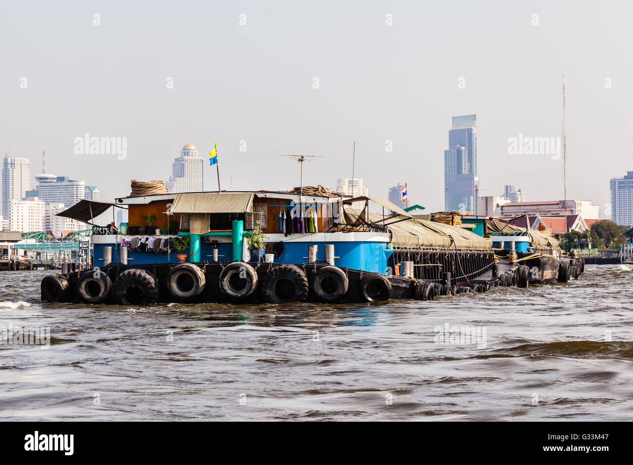 a very big barge floating on Chao Praya River in Bangkok, Thailand ...
