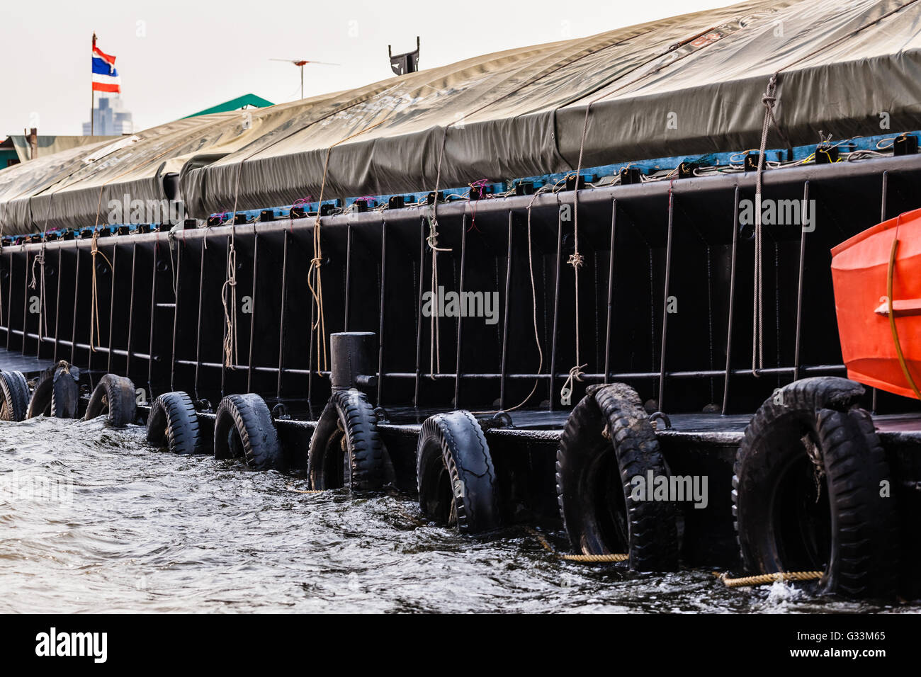 a very big barge floating on Chao Praya River in Bangkok, Thailand ...