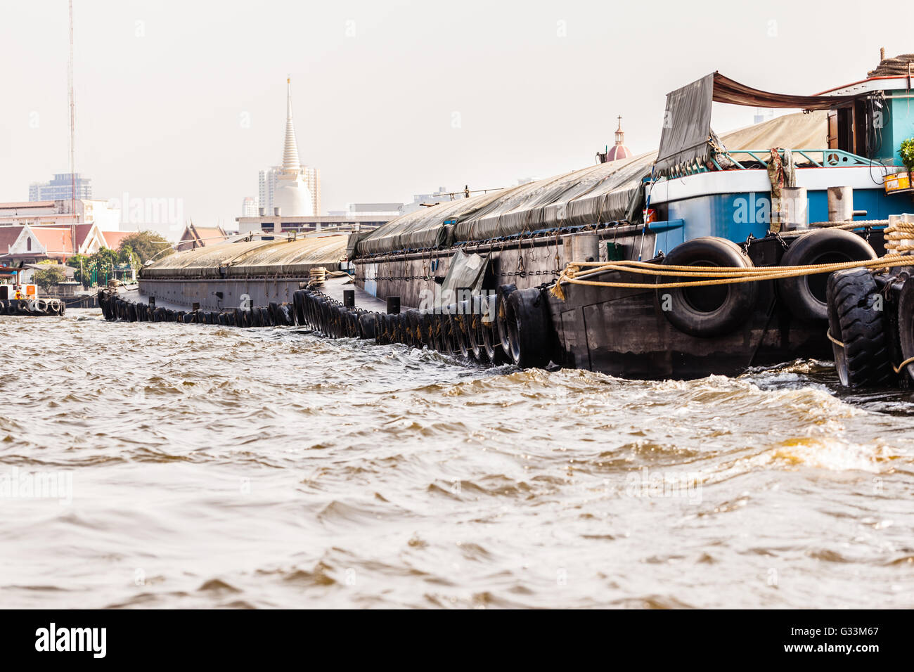 a very big barge floating on Chao Praya River in Bangkok, Thailand ...