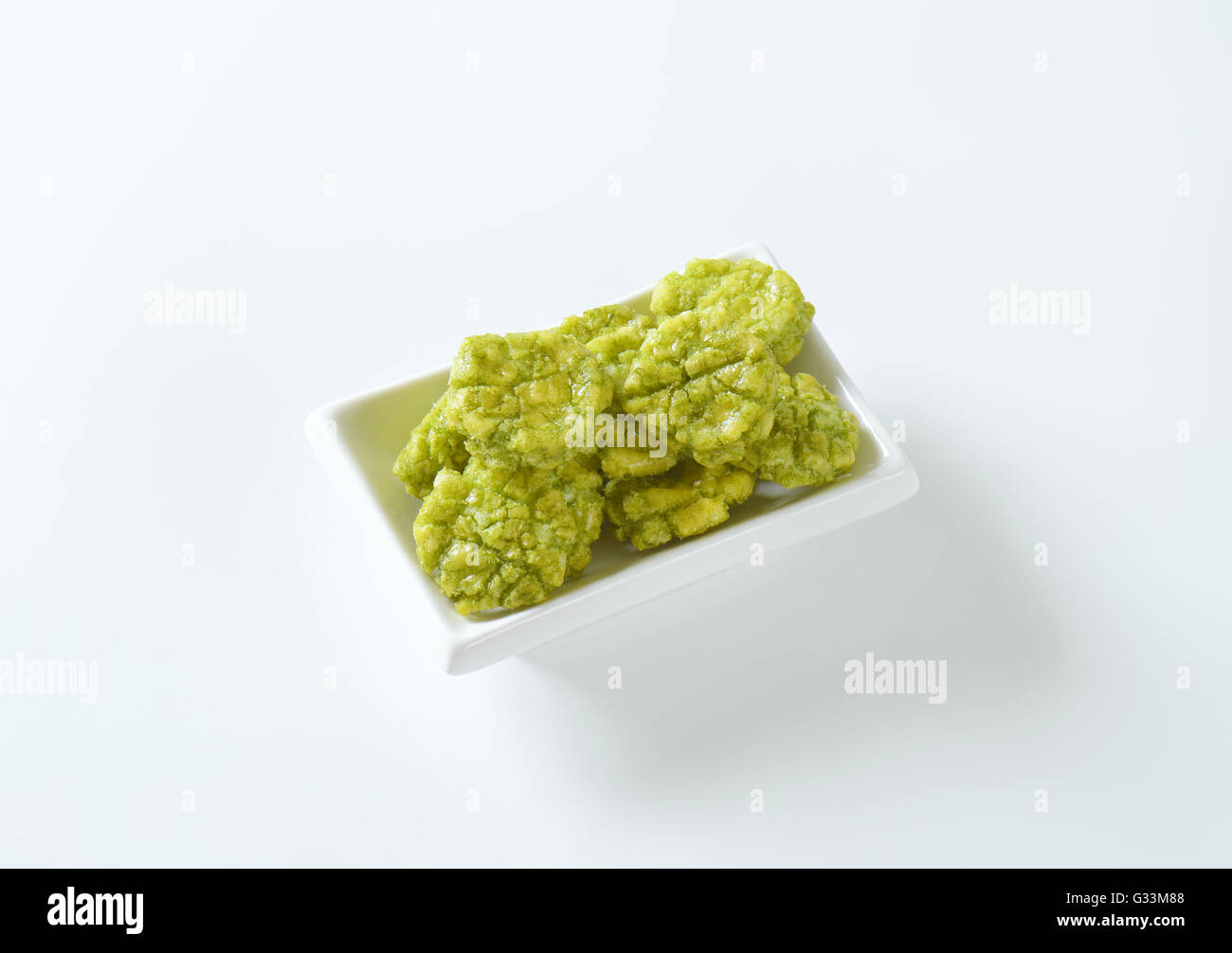 bowl of wasabi crackers on white background Stock Photo - Alamy