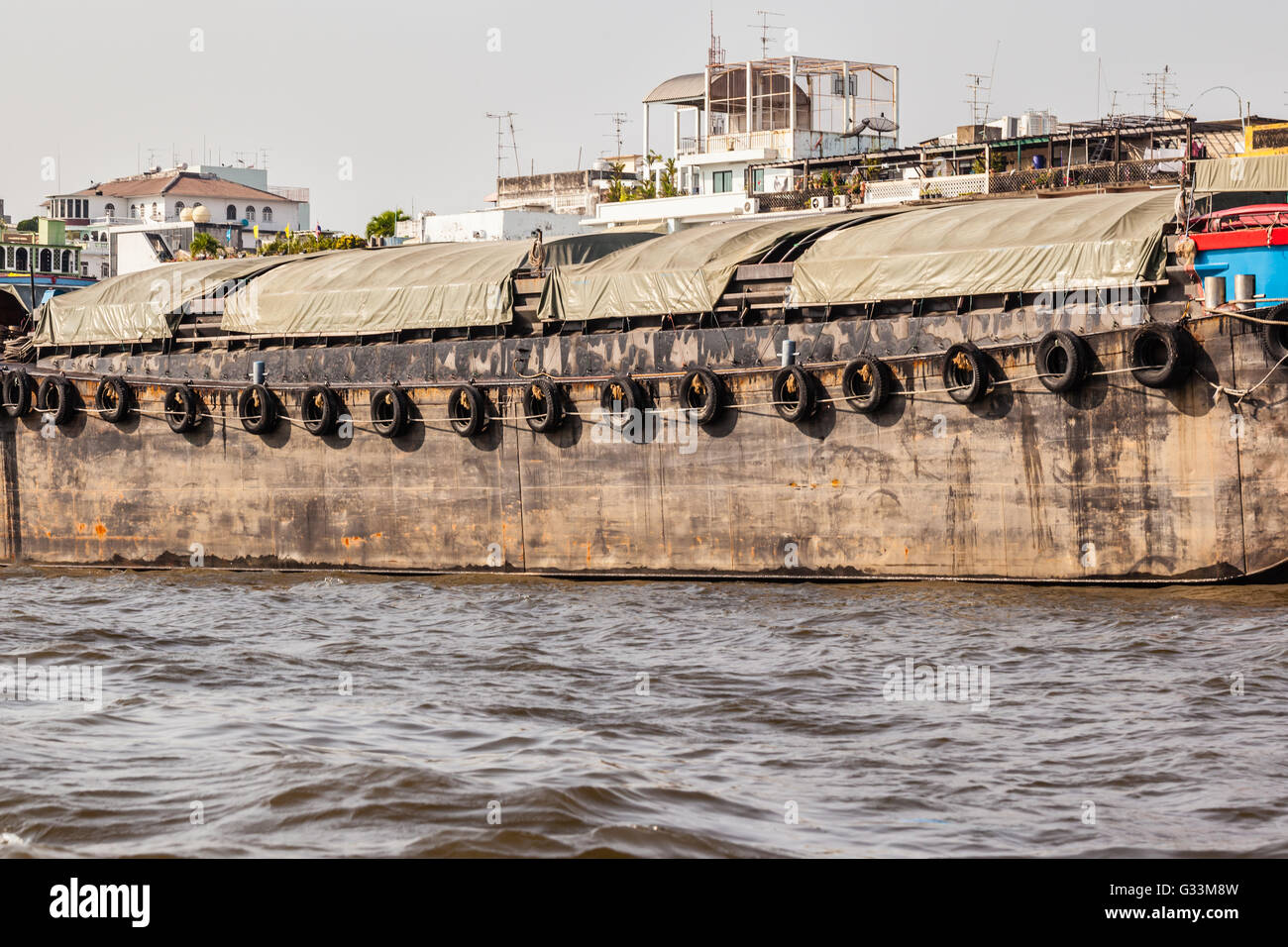 a very big barge floating on Chao Praya River in Bangkok, Thailand ...
