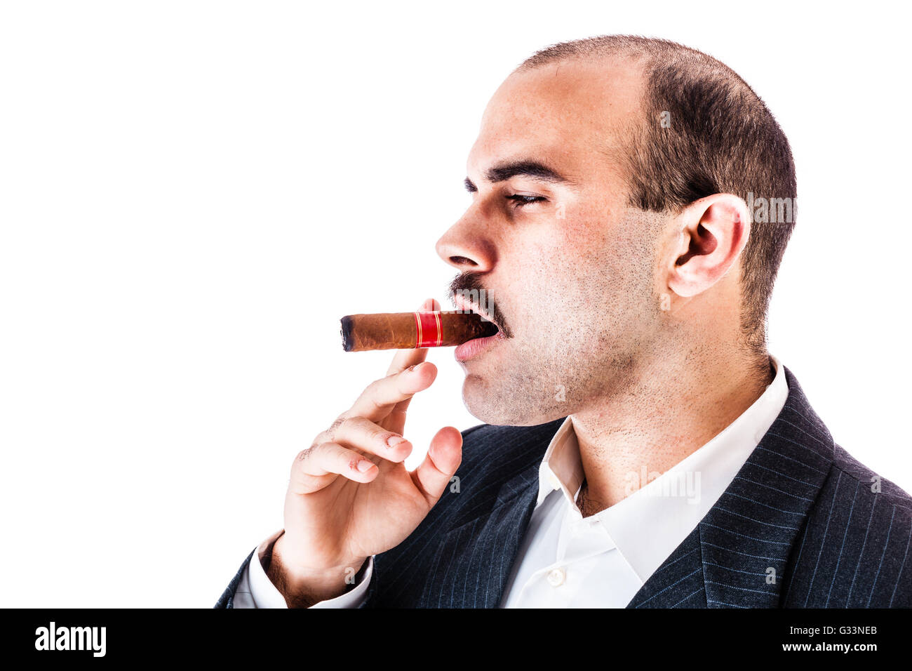 portrait of a rich businessman smoking a big cigar isolated over a ...