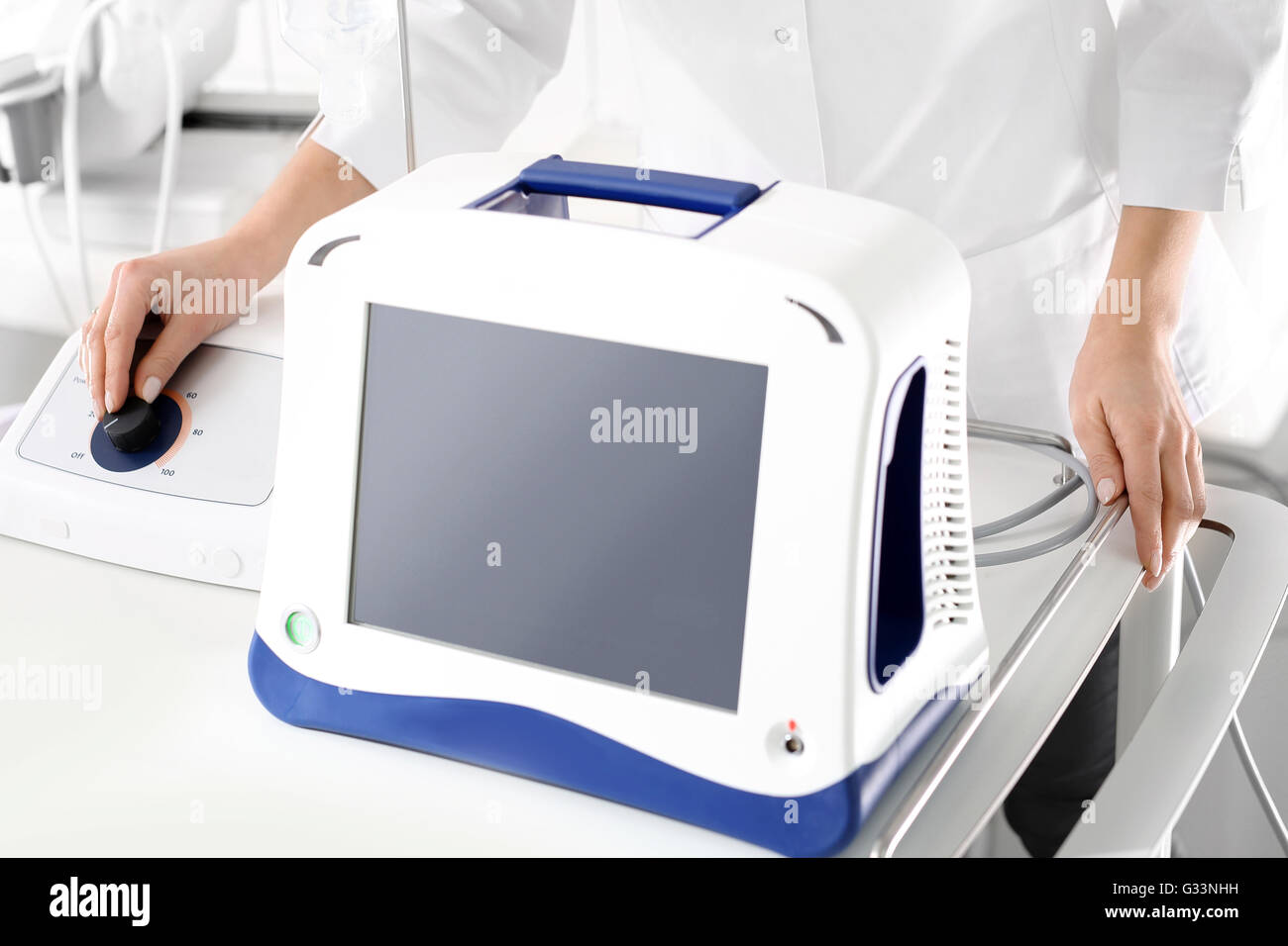 Operating room nurse connects the machine to remove varicose veins ...