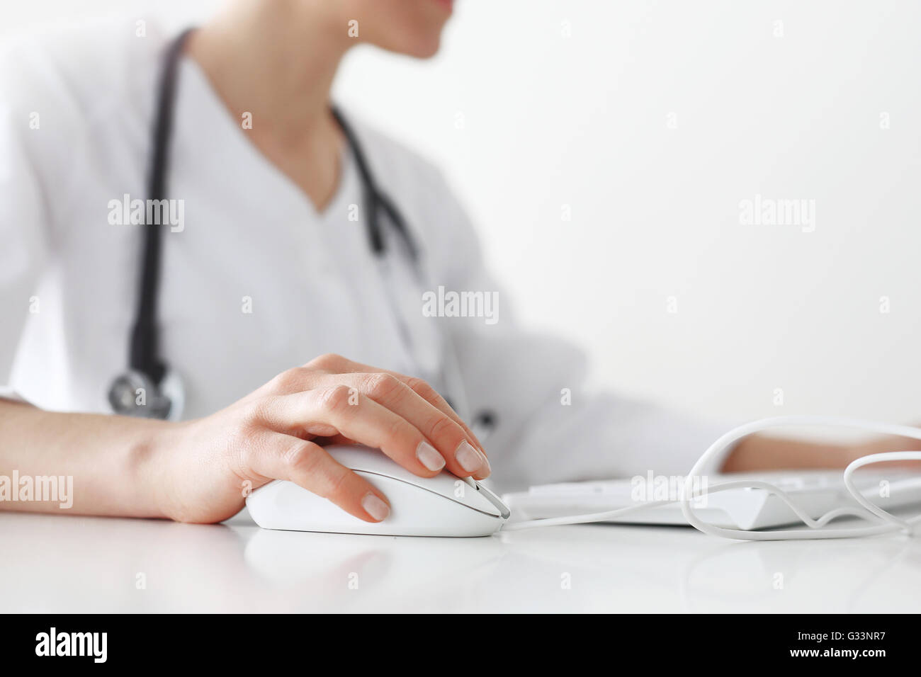 A doctor at the desk using the computer Stock Photo - Alamy