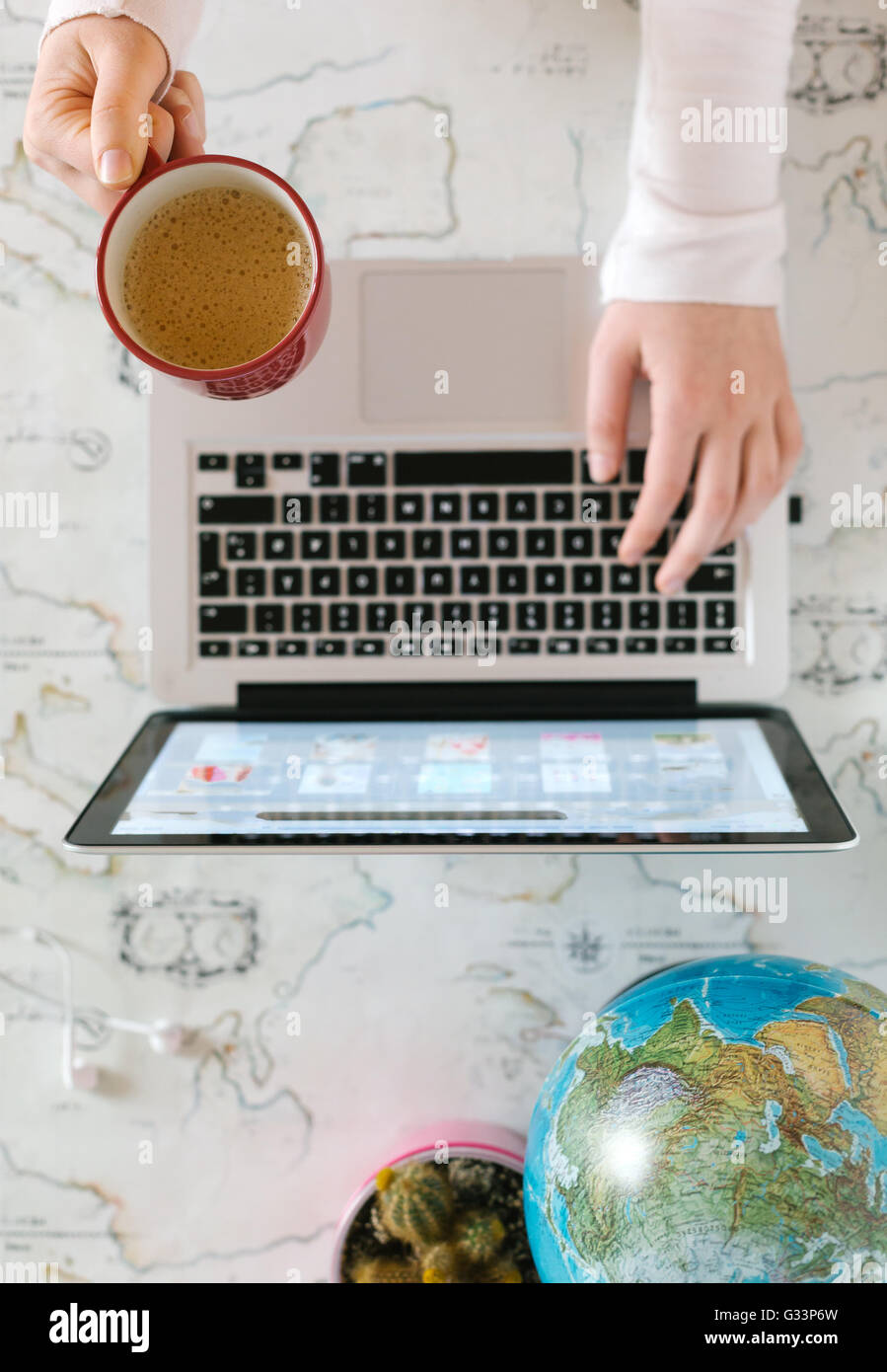 Woman typing on a computer and writing a note Stock Photo - Alamy
