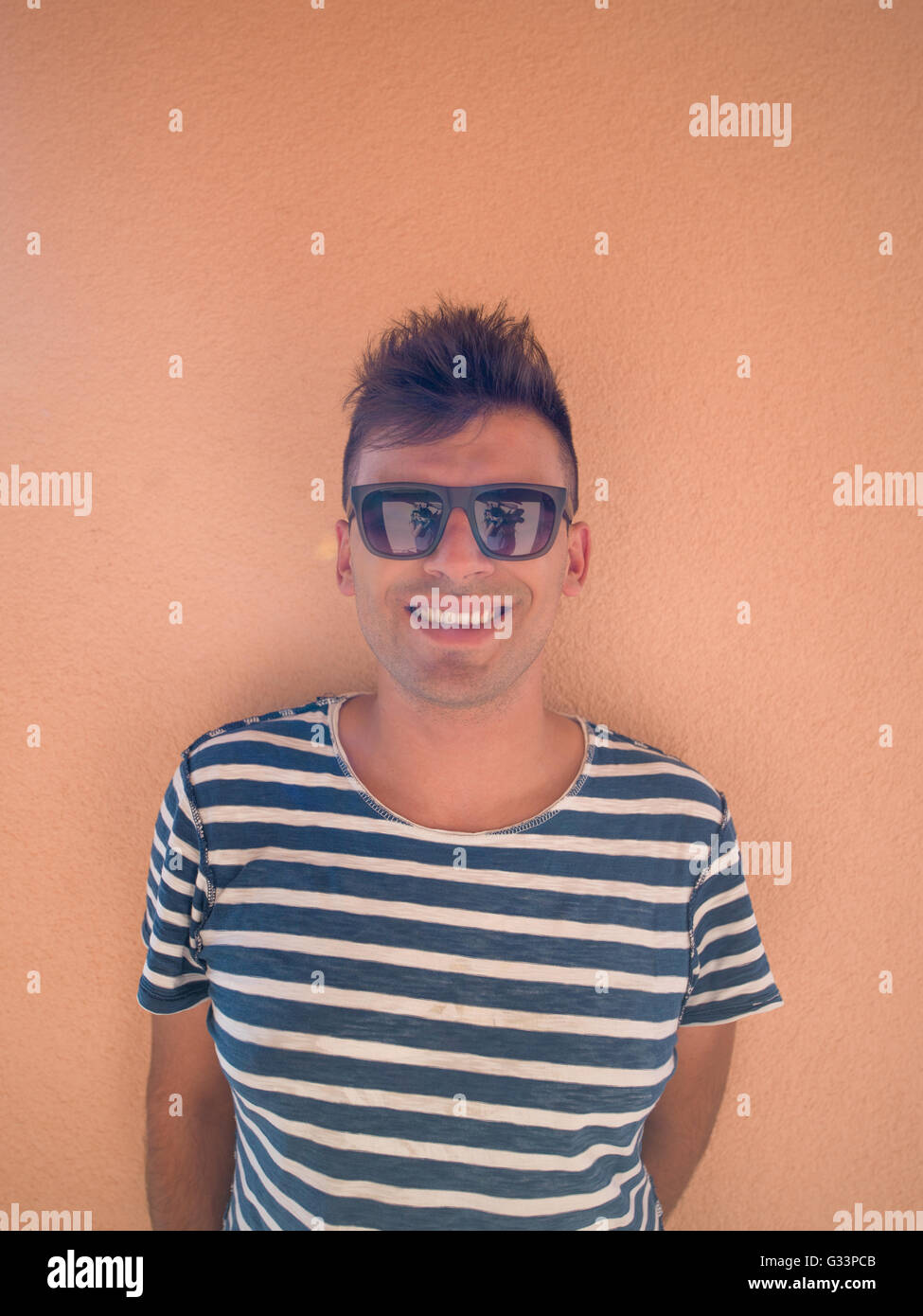 Young handsome man with great smile against neutral background with ...