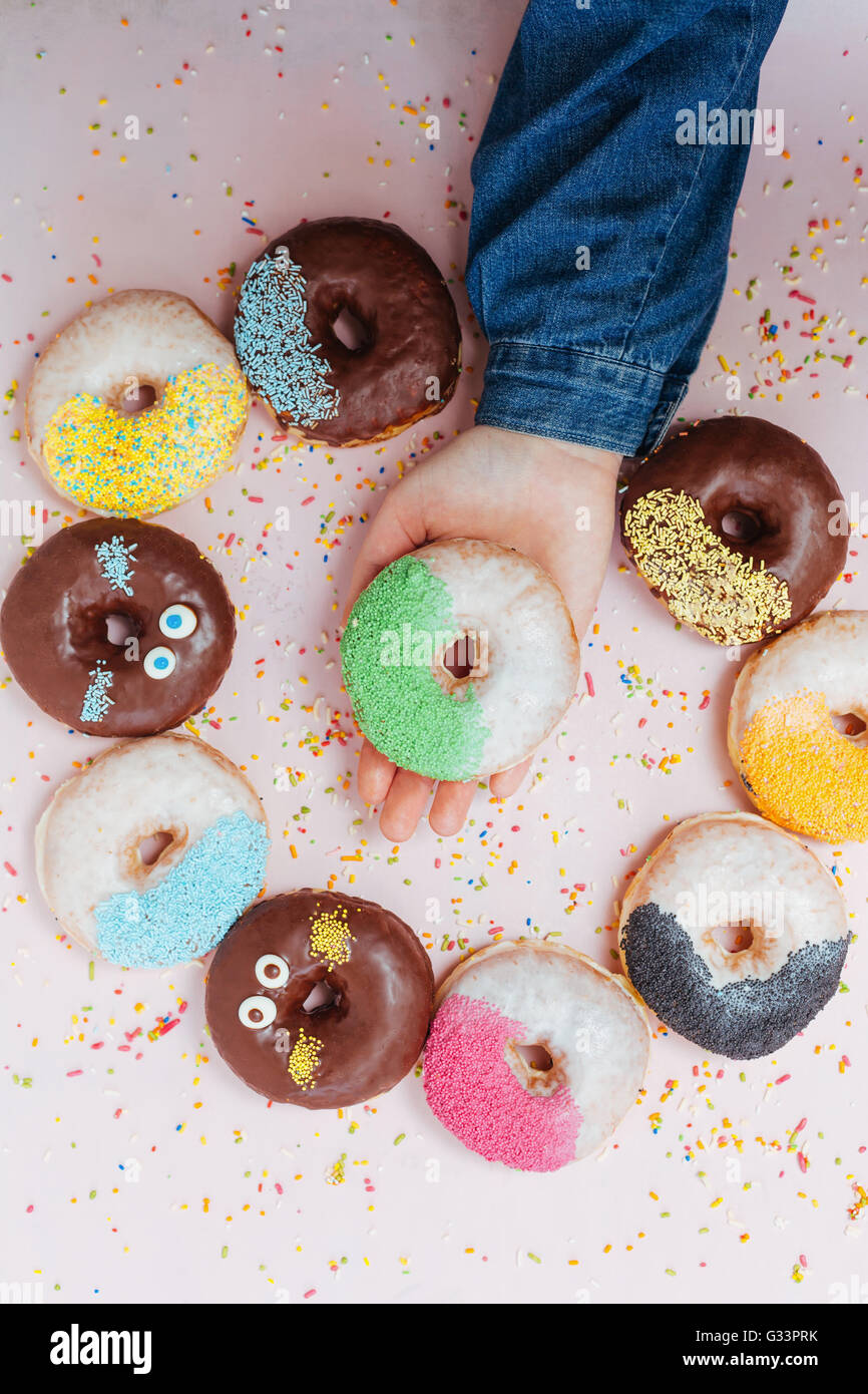 Hand grabbing donut hi-res stock photography and images - Alamy