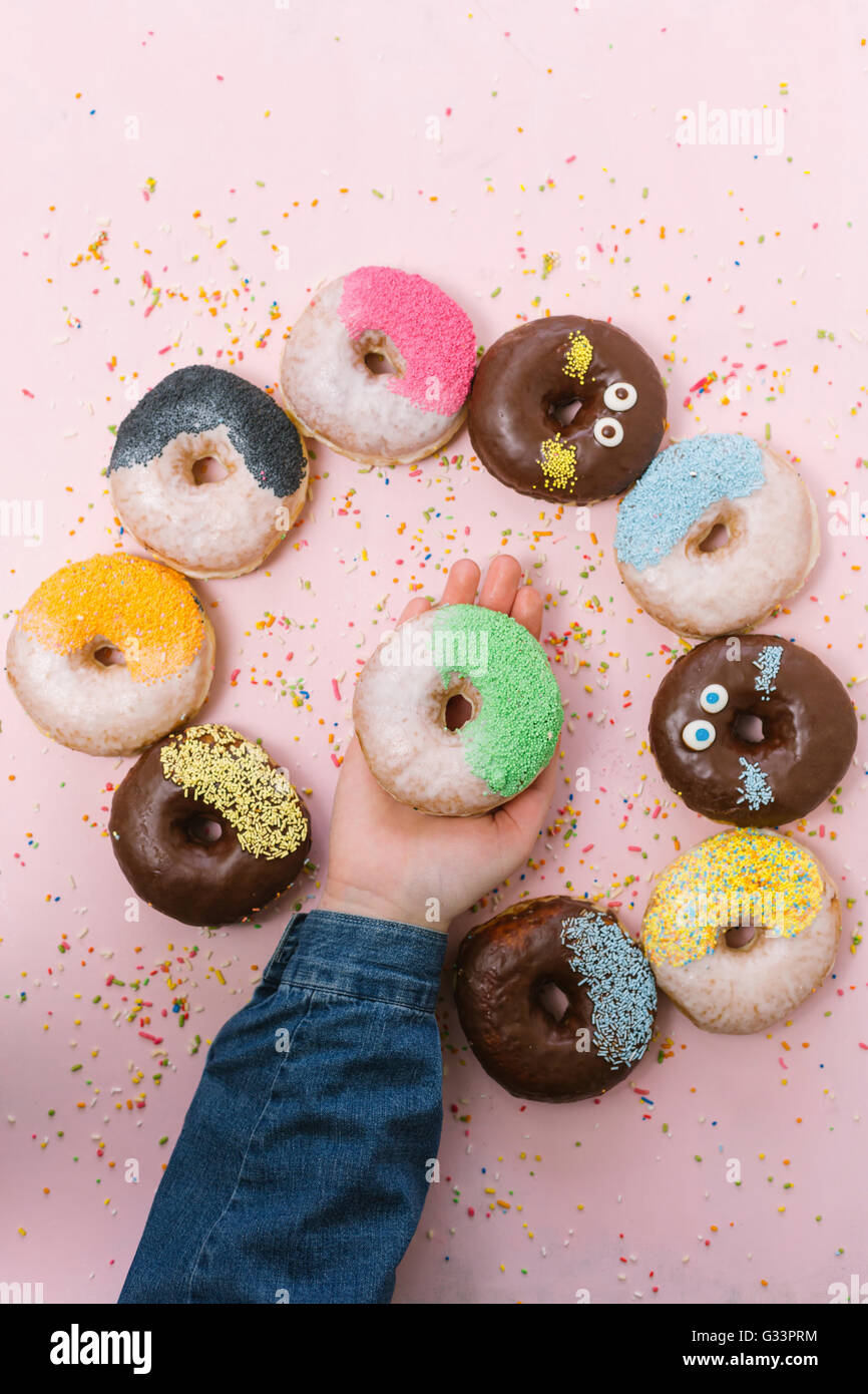 female hand reaching to grab the doughnut Stock Photo - Alamy