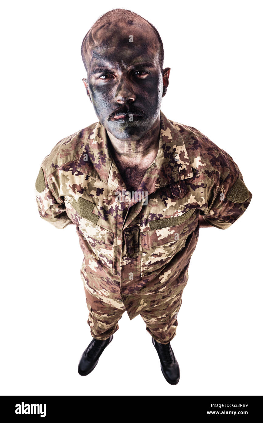 a soldier wearing camouflage clothing and army face paint isolated over ...