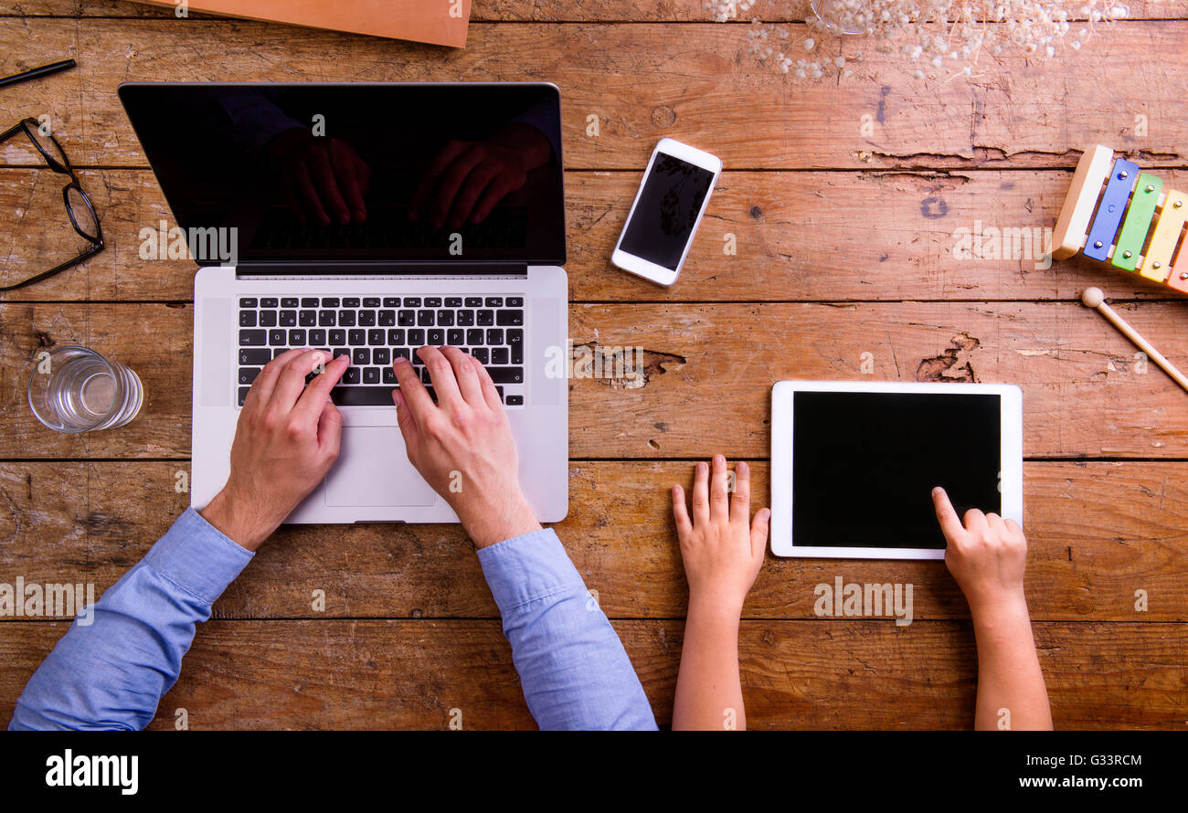 Father and son, office desk with laptop and tablet Stock Photo - Alamy