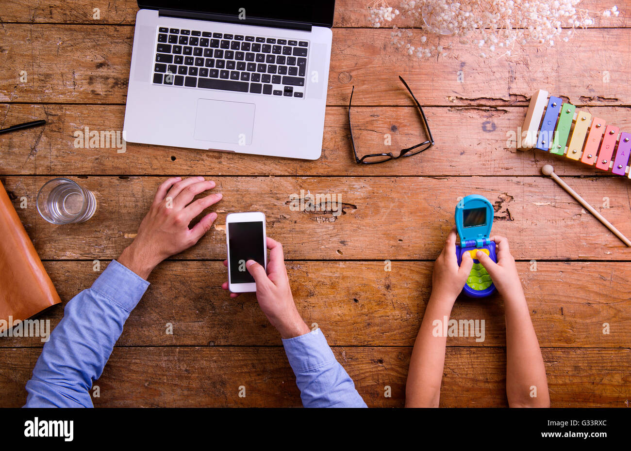 Father and son, office desk with laptop and smartphone Stock Photo - Alamy