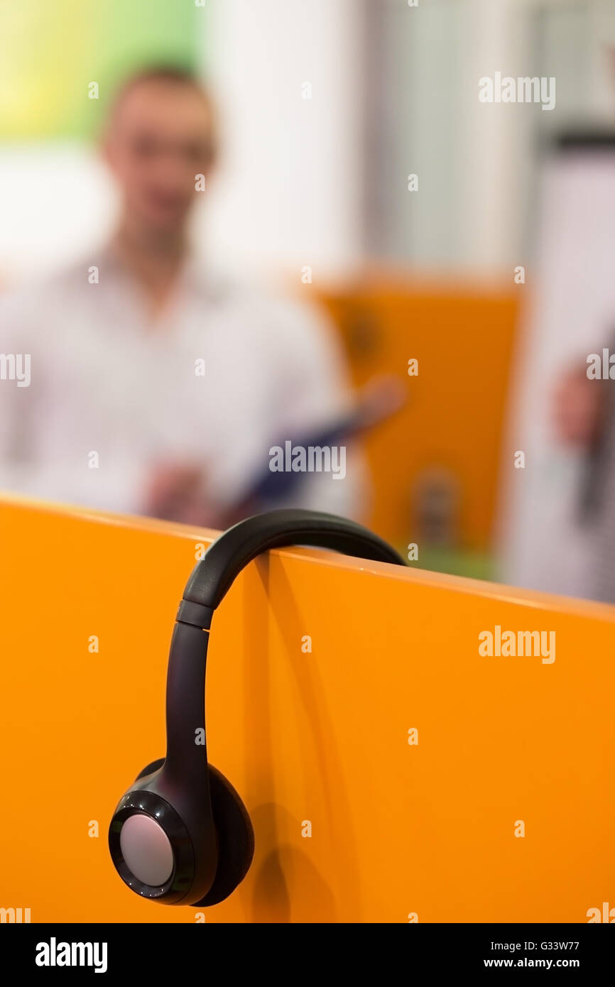 Headphones hanging on cubicle partition in empty office Stock Photo - Alamy