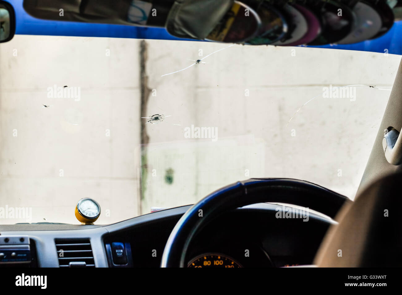two bullet impact cracks on the windshield of a car Stock Photo - Alamy