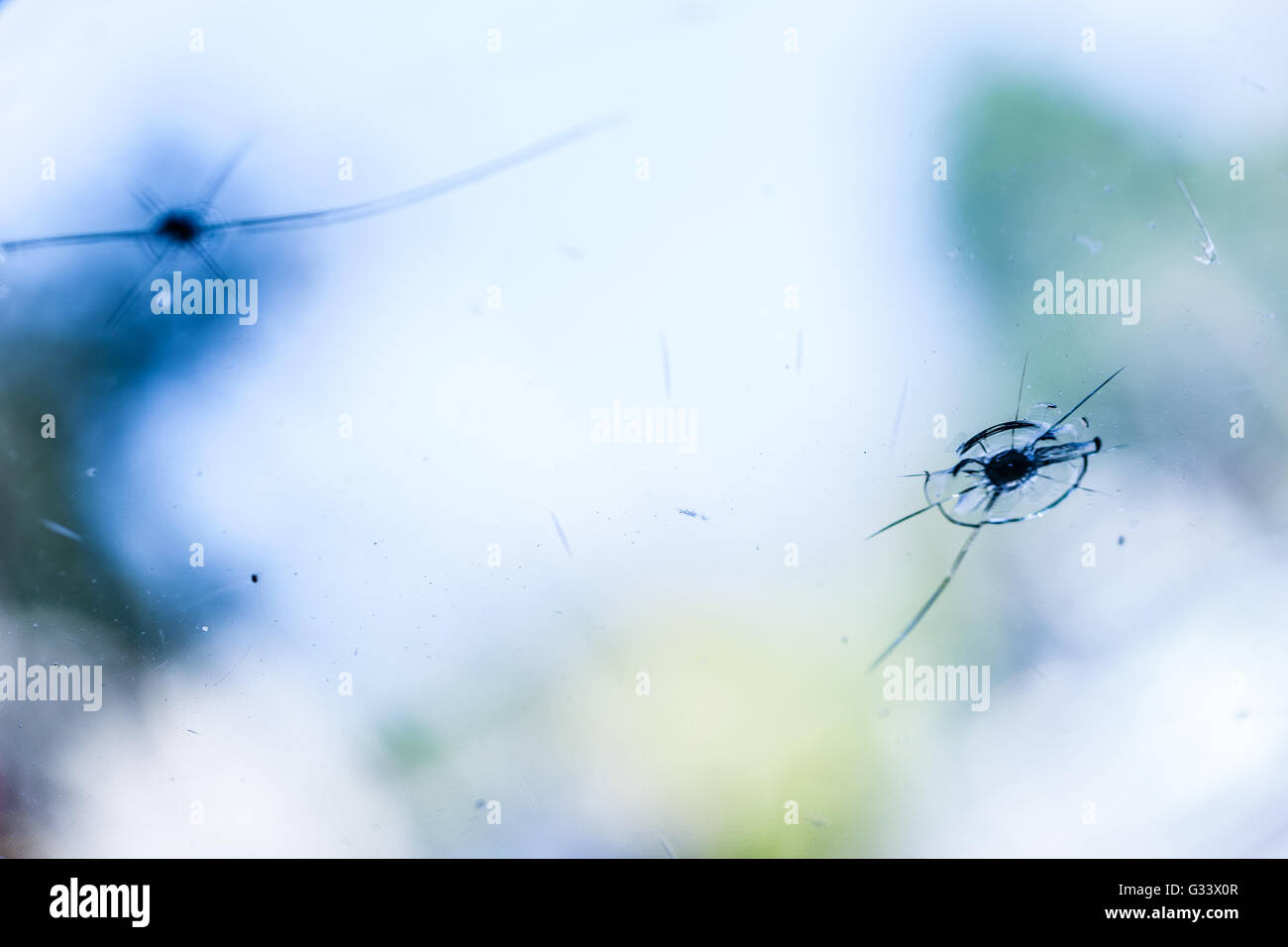 two bullet impact cracks on the windshield of a car Stock Photo - Alamy