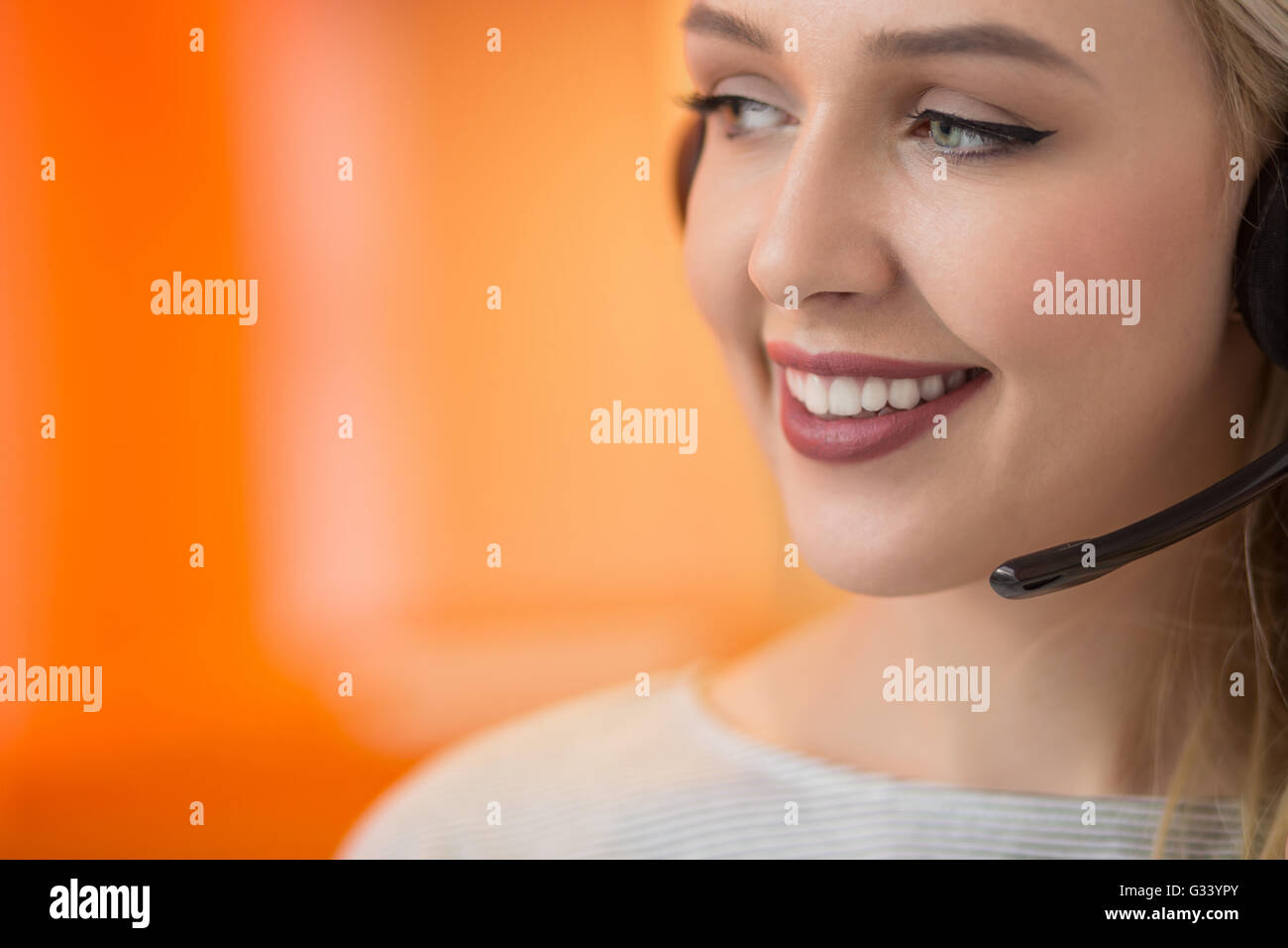 Close-up portrait of a customer service agent sitting at office Stock ...