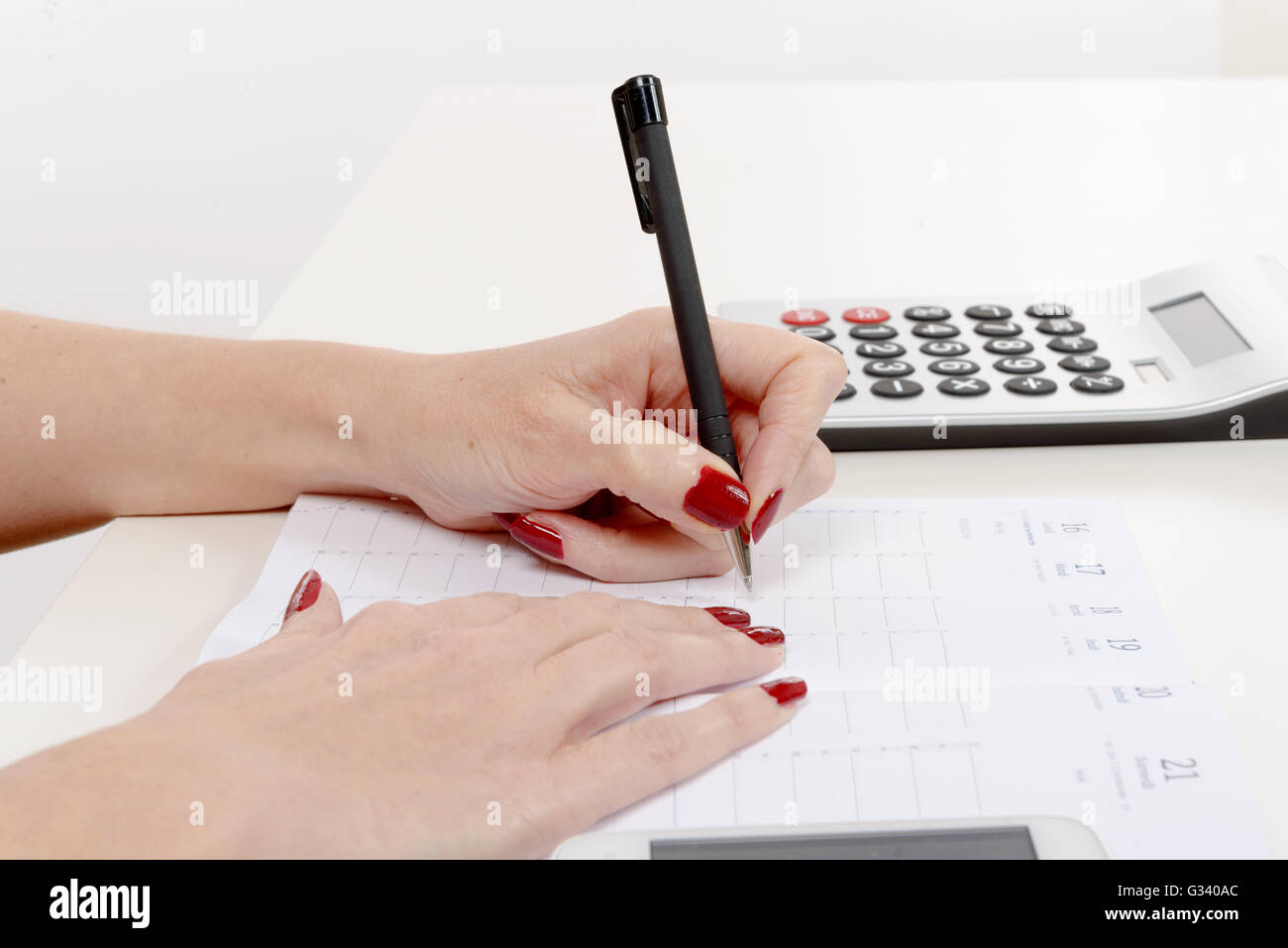 a closeup of woman's hand writing on paper Stock Photo - Alamy