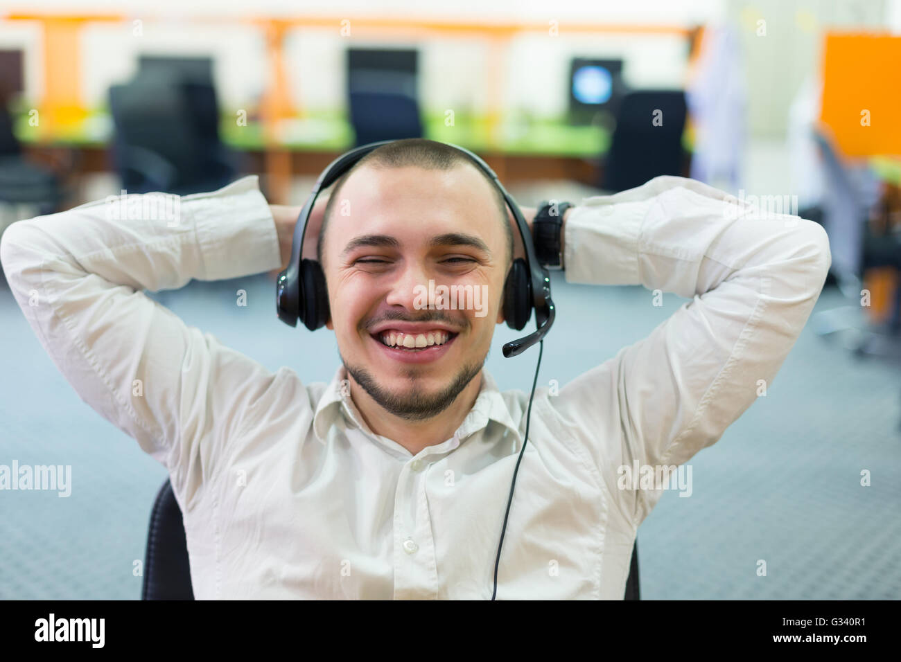 Satisfied with work done. Happy young man working on computer while ...