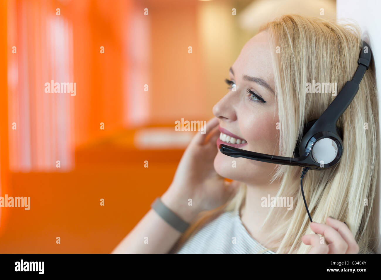 Close-up portrait of a customer service agent sitting at office Stock ...