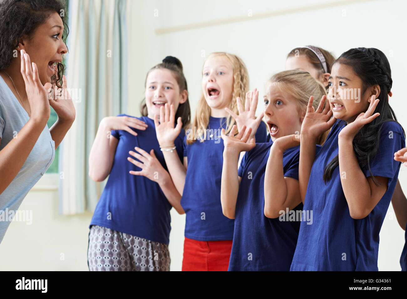 Group Of Children With Teacher Enjoying Drama Class Together Stock ...