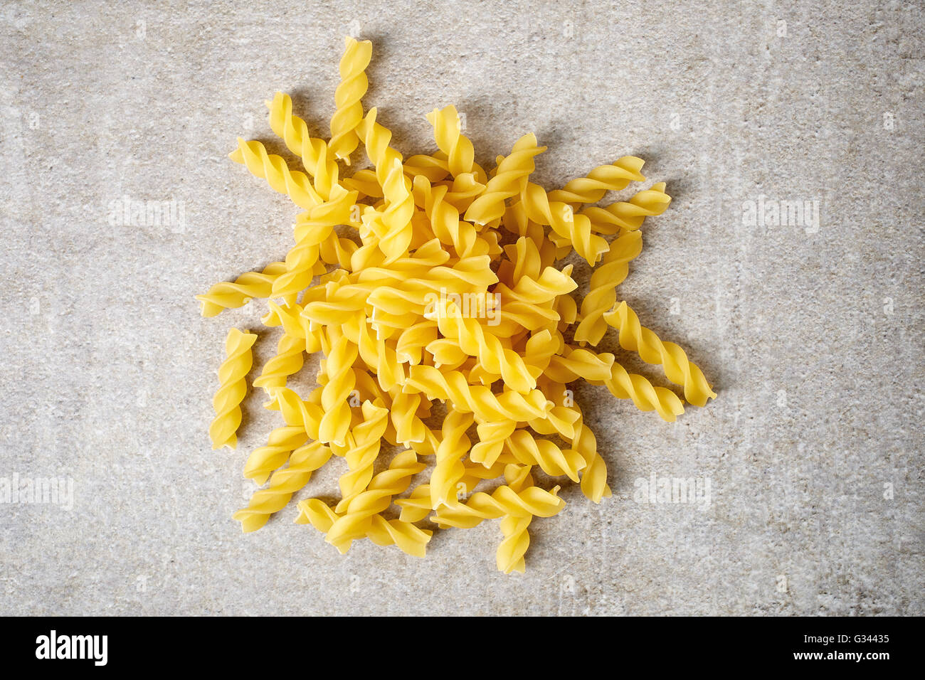 Spiral pasta on stone table, top view Stock Photo - Alamy