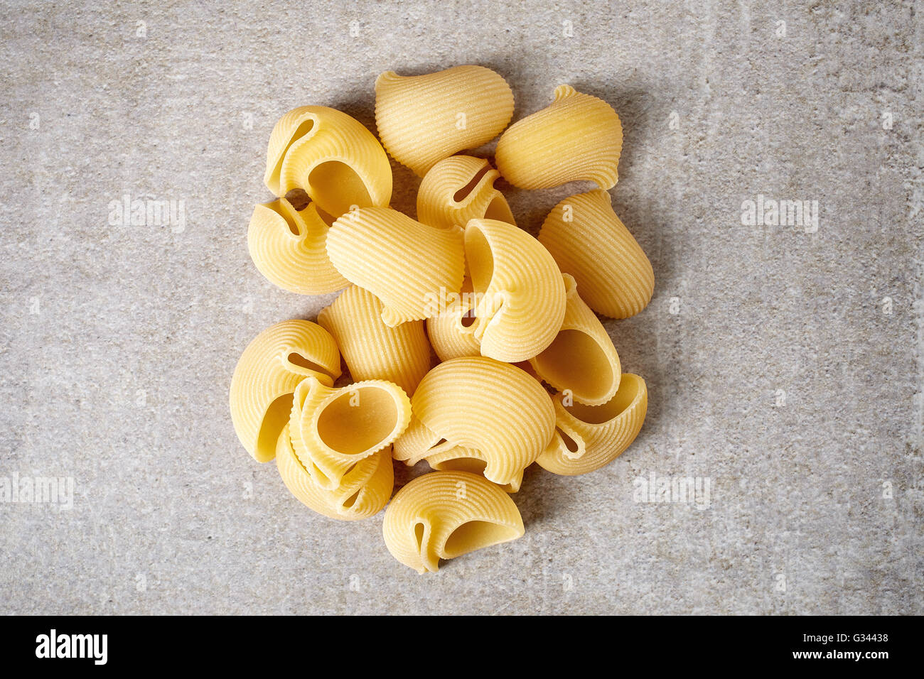 Pasta shells on stone table, top view Stock Photo - Alamy