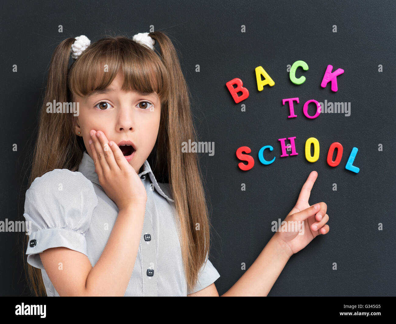 Shocked schoolgirl at the chalkboard Stock Photo - Alamy