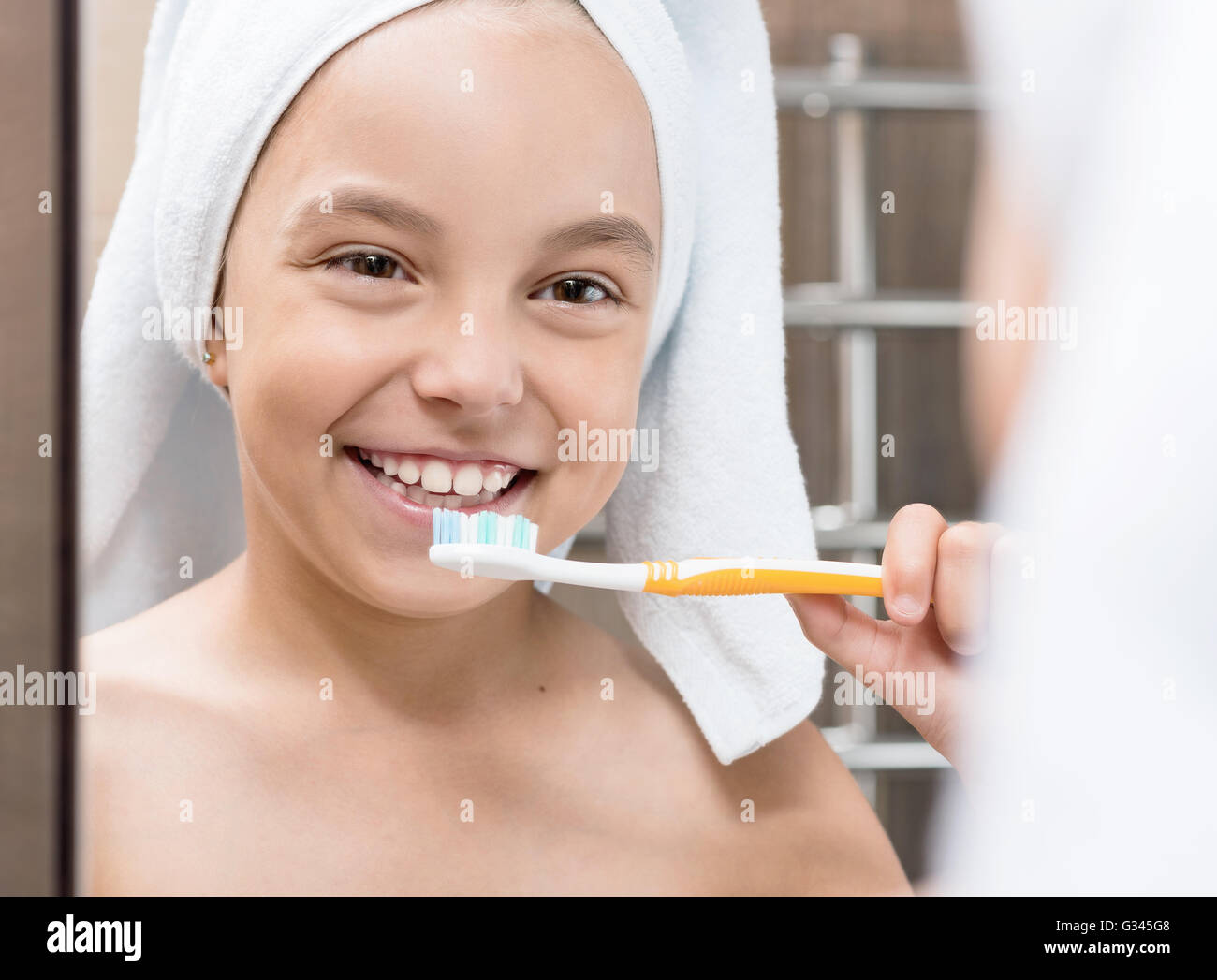 Smiling little girl brushing teeth Stock Photo - Alamy