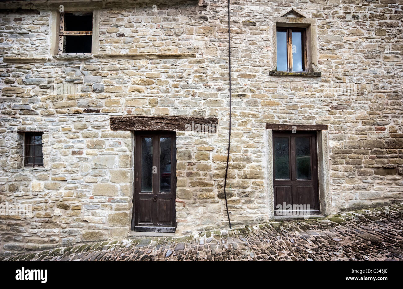 Front view of medieval stone house façade Stock Photo - Alamy