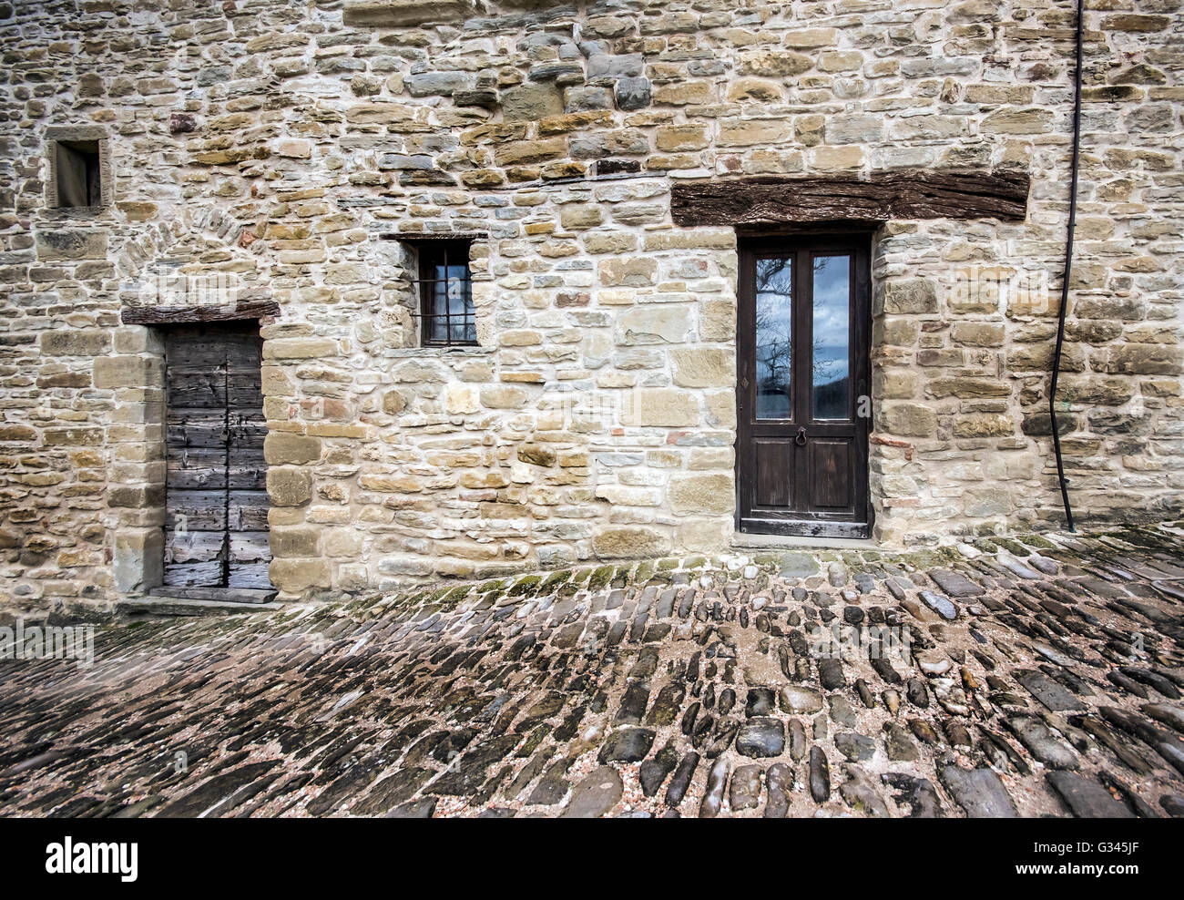 Front view of a medieval stone façade house and cobble street Stock ...