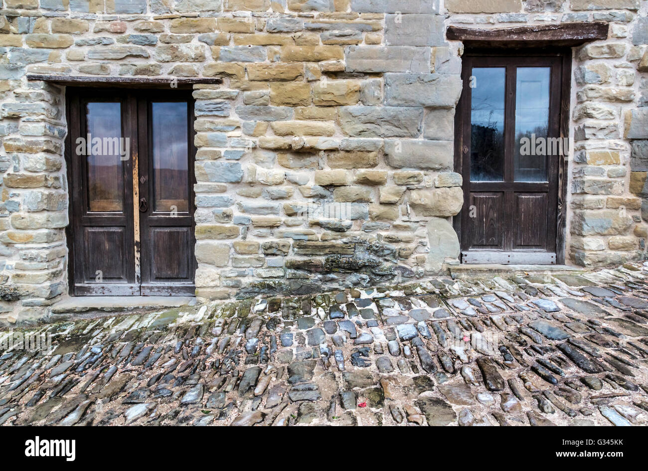 Front view of a medieval stone house façade at ground level Stock Photo ...