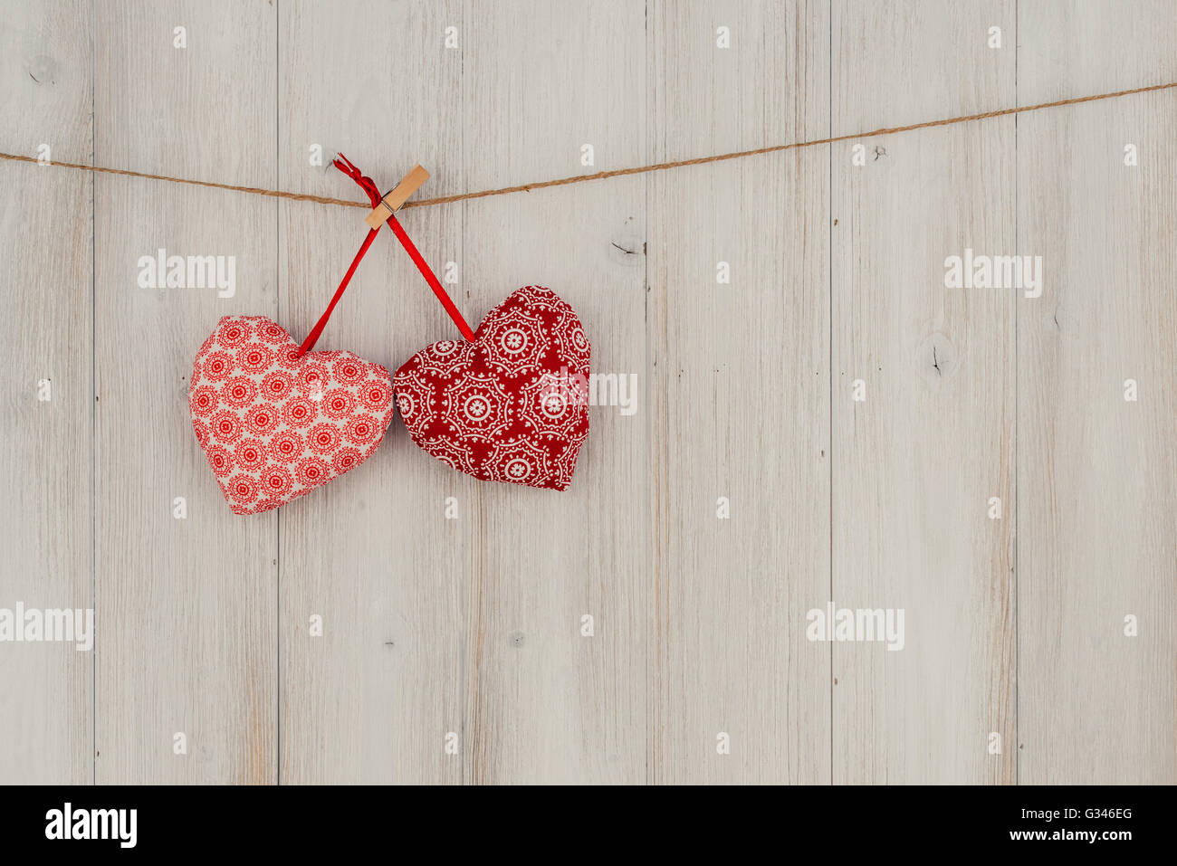 Red heart hanging on the clothesline. On old wood background Stock ...