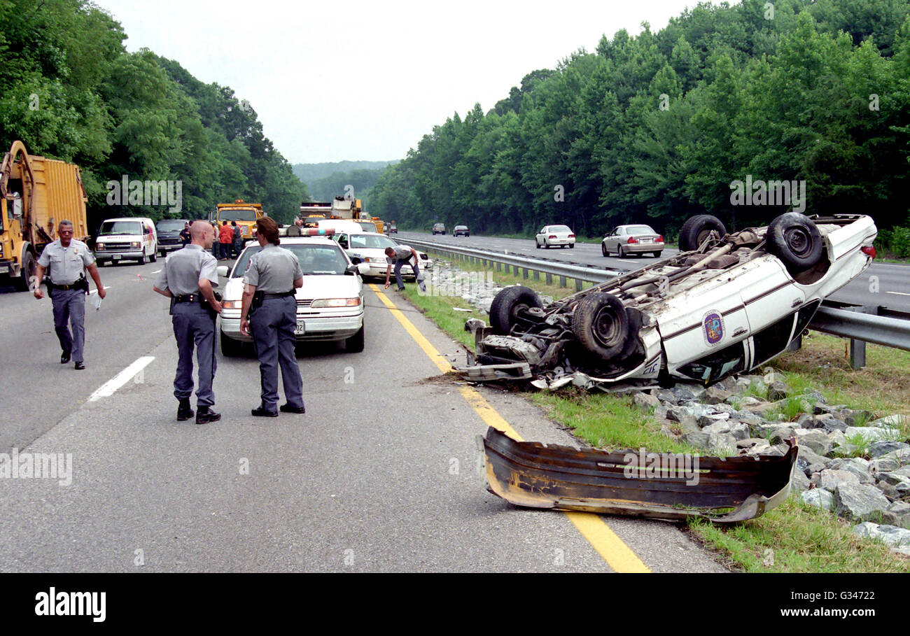 police investigate a accident involving a flipped over police car in ...