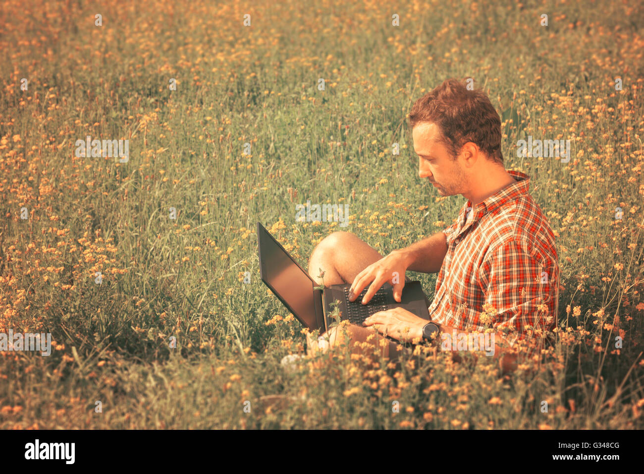 Young man with the laptop outdoor Stock Photo - Alamy