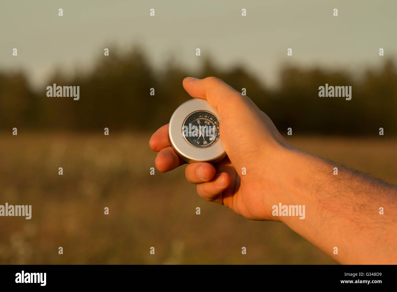 Holding a compass Stock Photo - Alamy