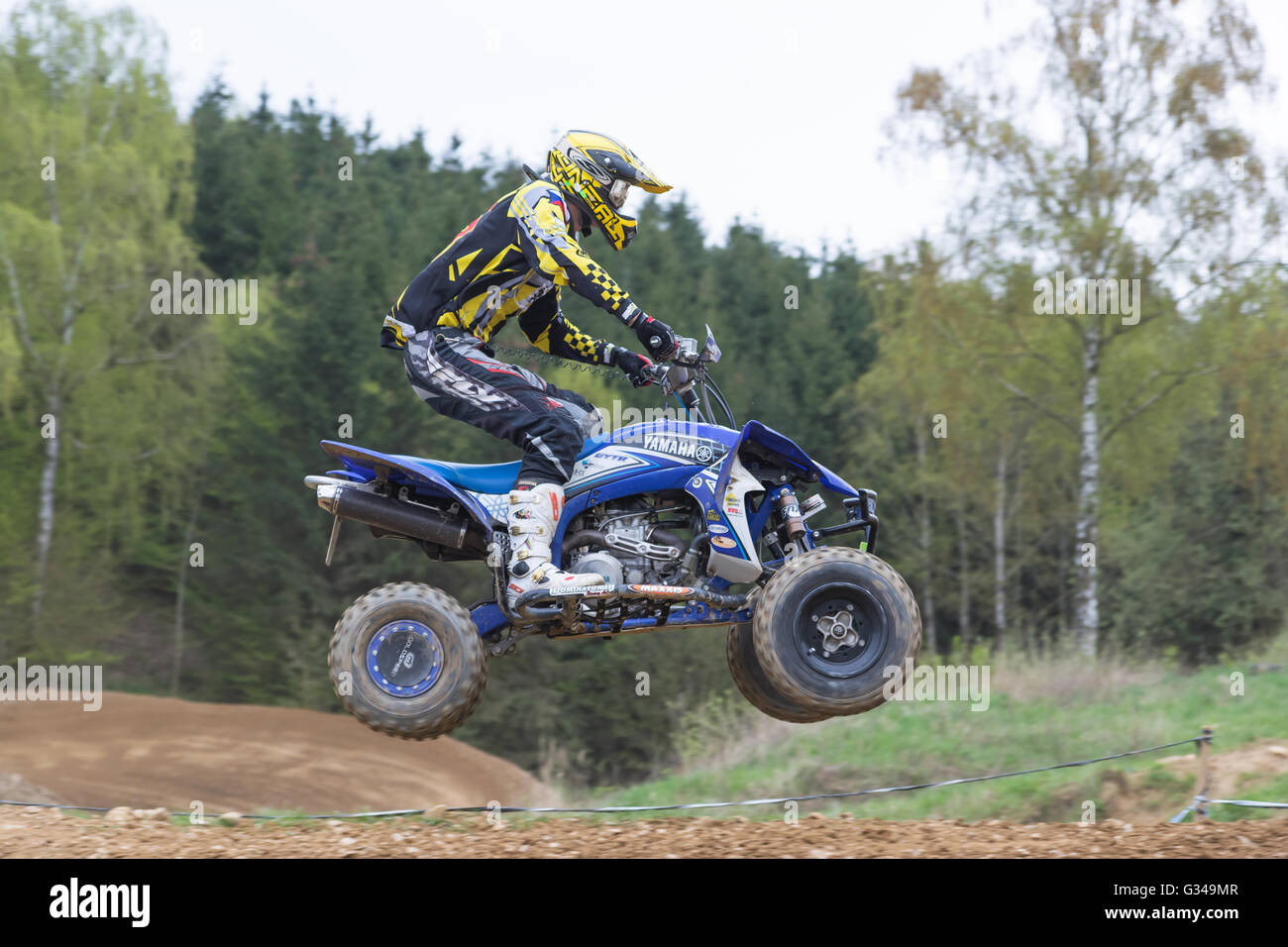 Quad rider is high jumping in the race Stock Photo - Alamy