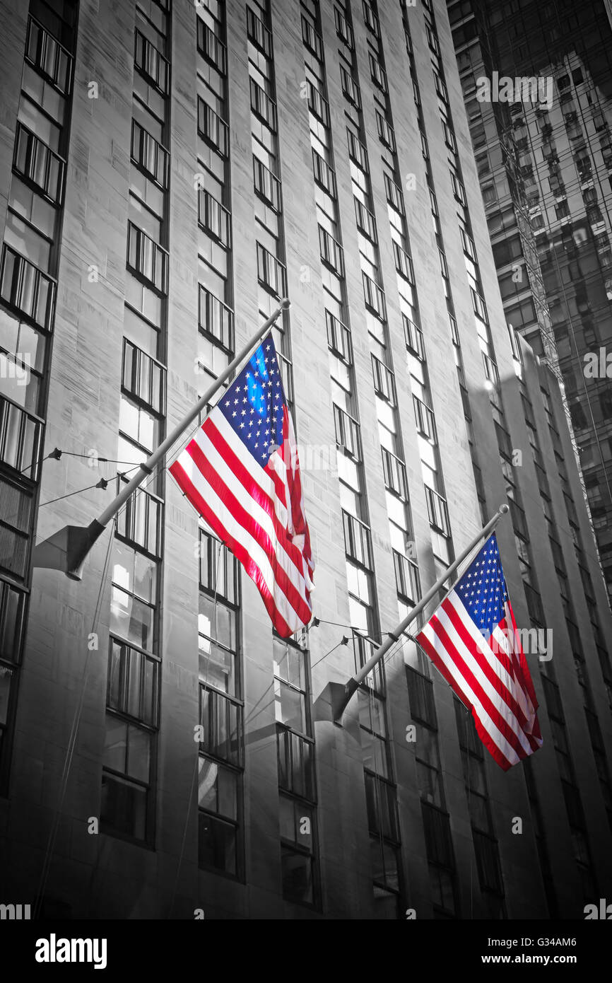 Two American flags with skyscraper background. Monochromatic photo with ...