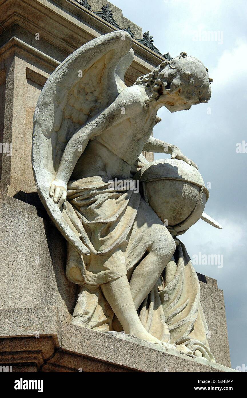 New York City: Statue of an angel holding a globe at the base of the ...