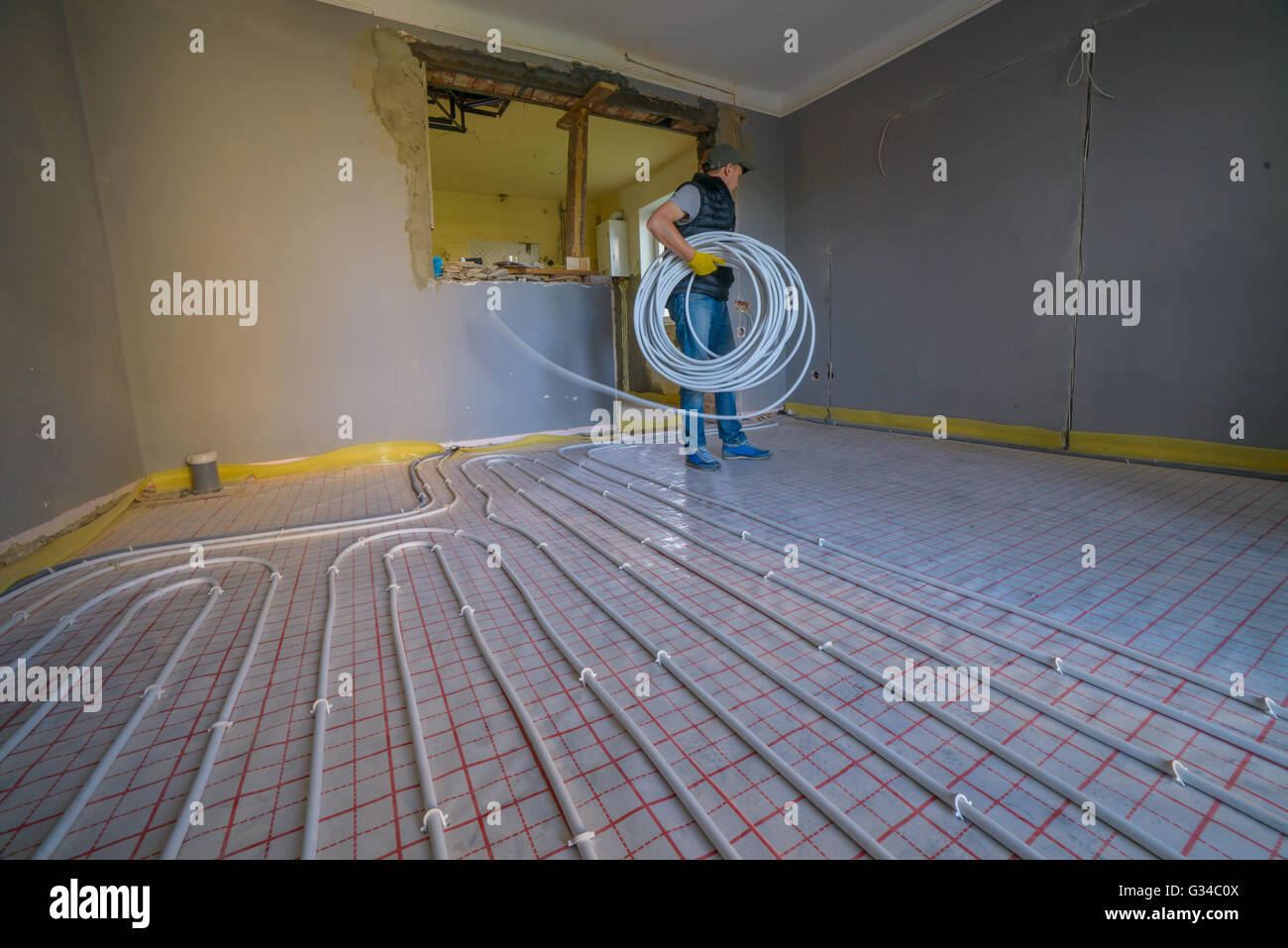 pipefitter installing system of heating Stock Photo - Alamy