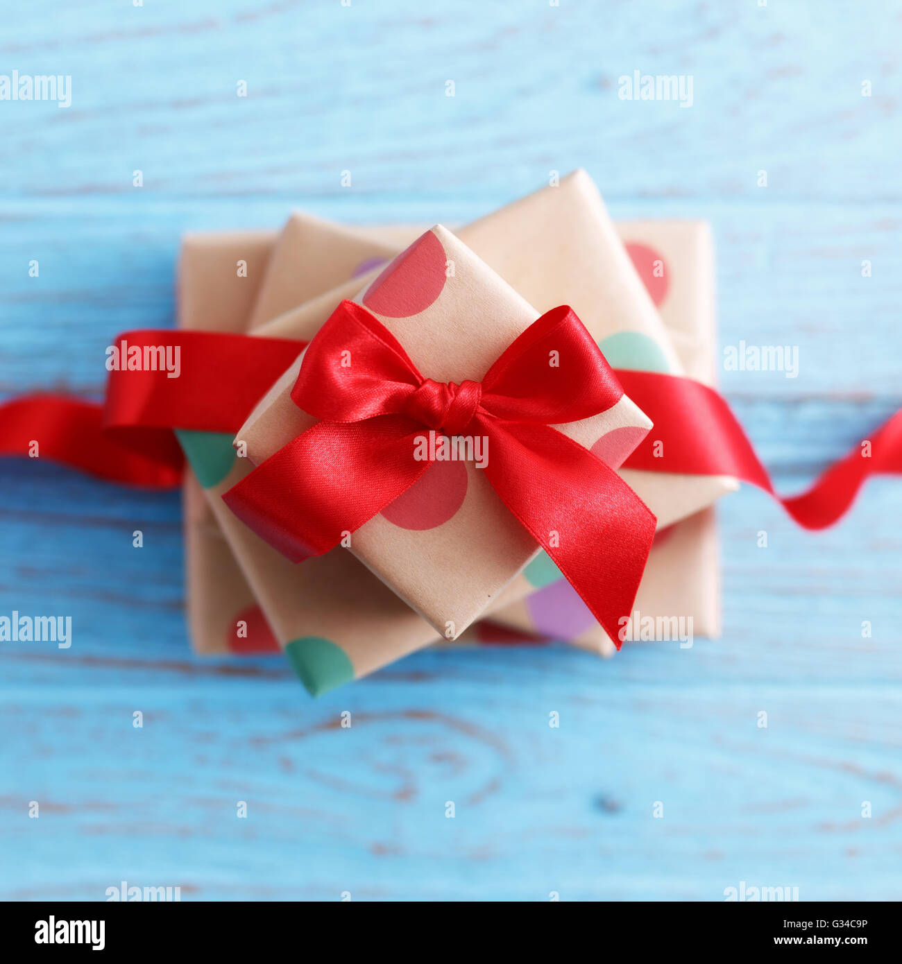 Presents for birthday with red bow and ribbon on wood table Stock Photo ...