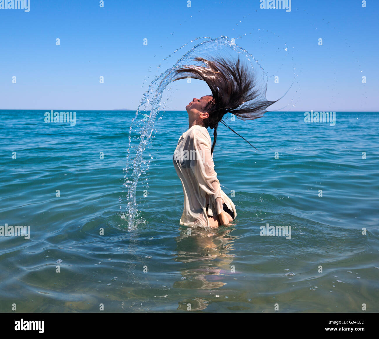 Woman splashing sea hi-res stock photography and images - Alamy