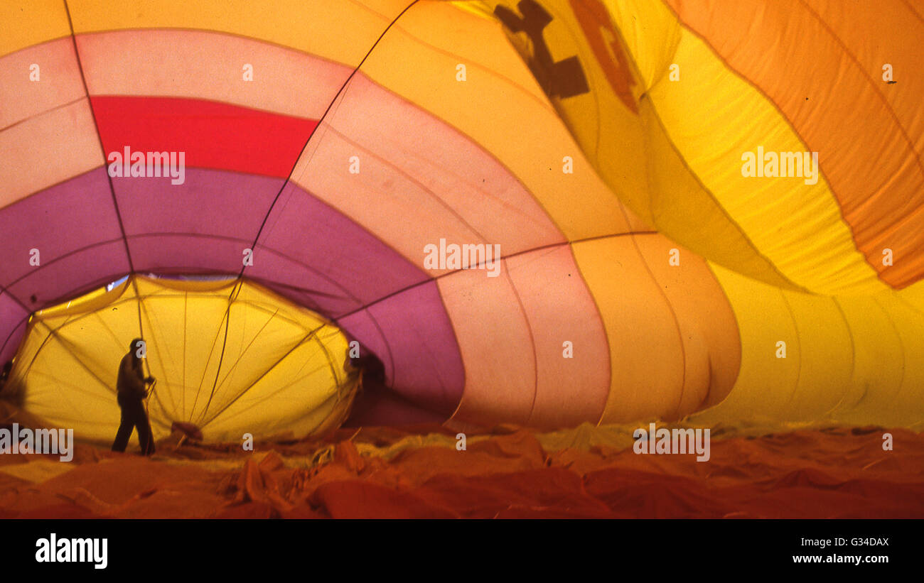 Getting the balloon ready for flight, the silhouette of a man, the ...