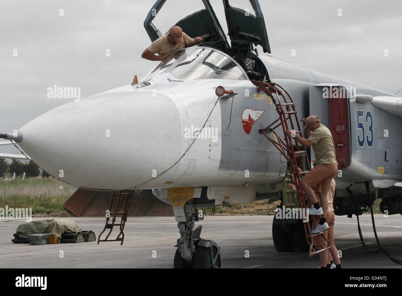 Soldiers prepare a Suchoi Su-24 heavy bomber for a mission at the ...