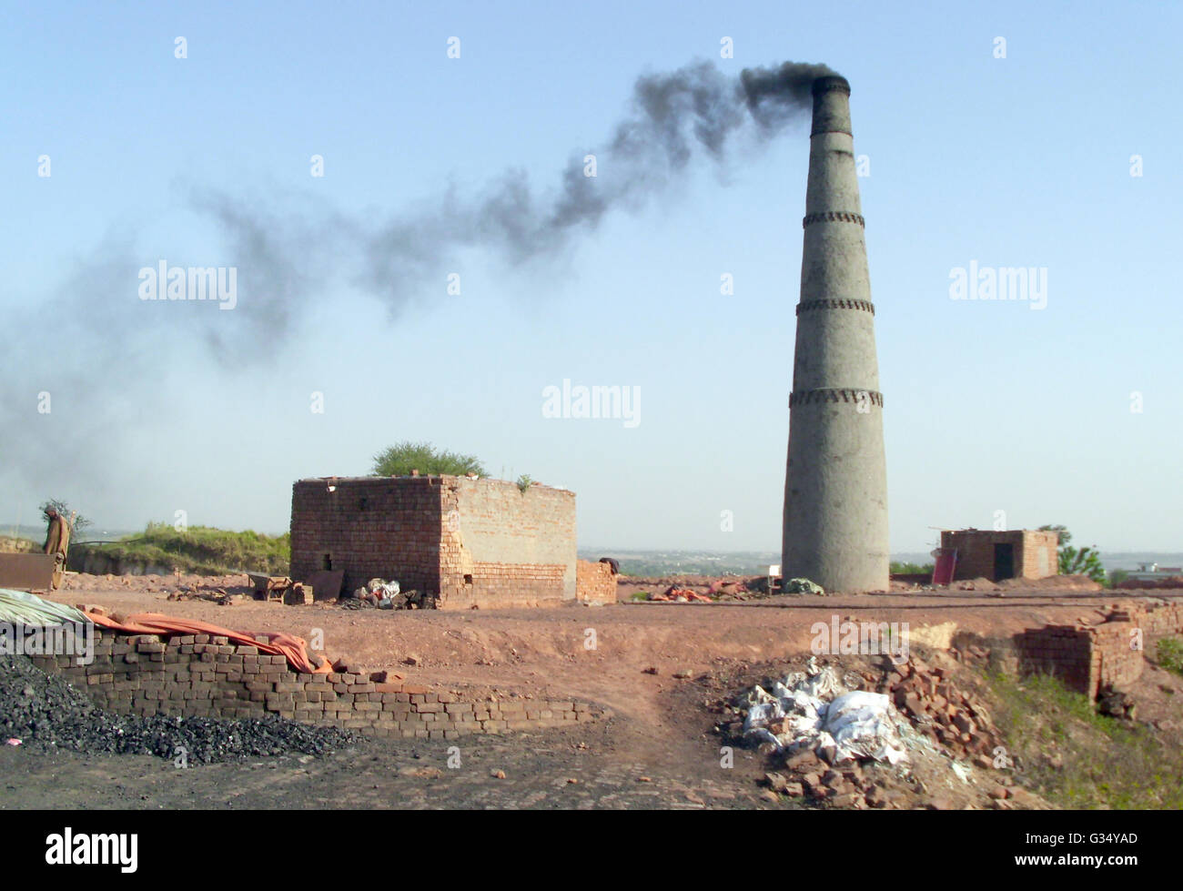 Islamabad, Pakistan. 27th Apr, 2016. Black smoke rises from a chimney ...