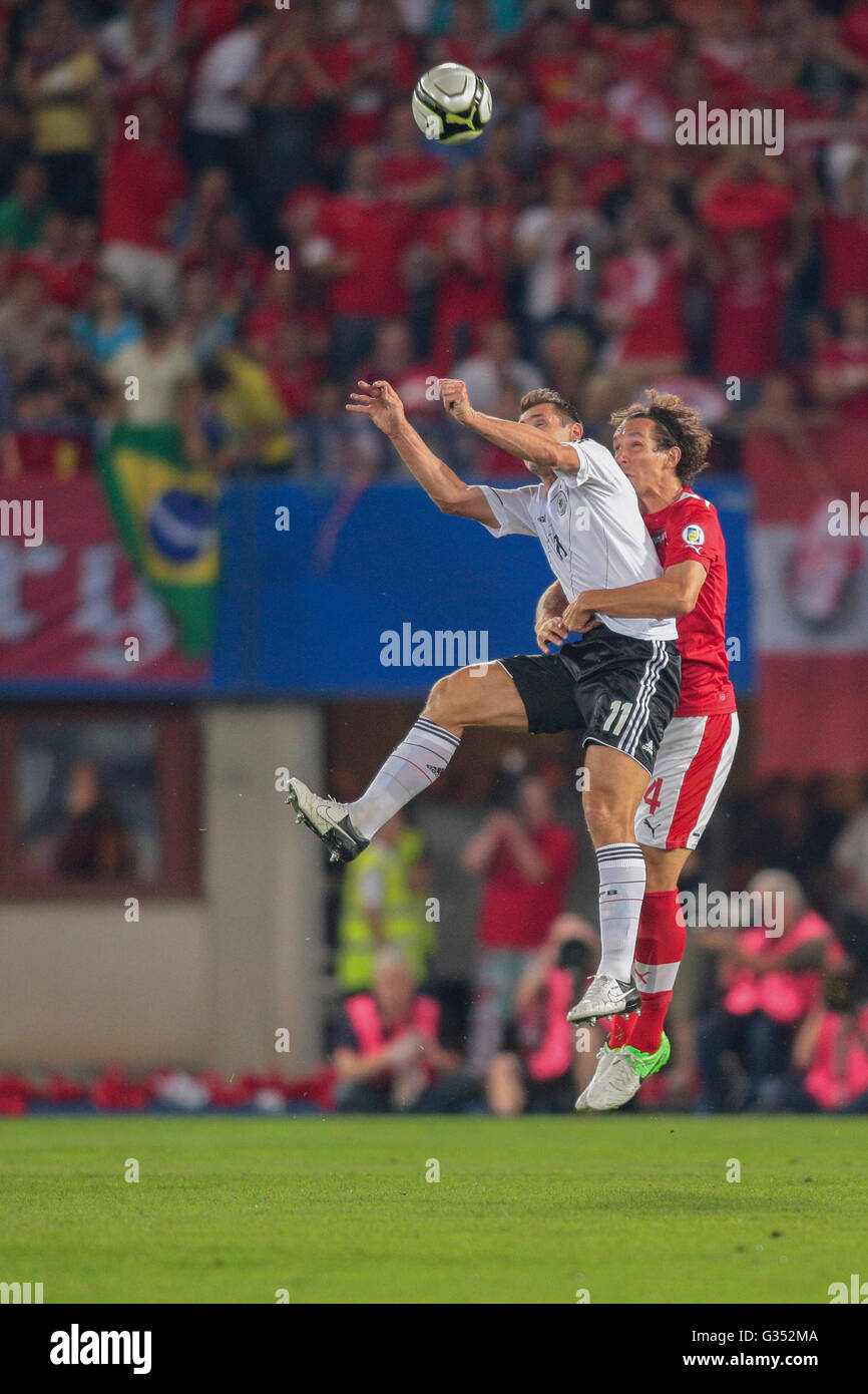 Emanuel Pogatetz, #4 Austria, and Miroslav Klose, #11 Germany, fight ...
