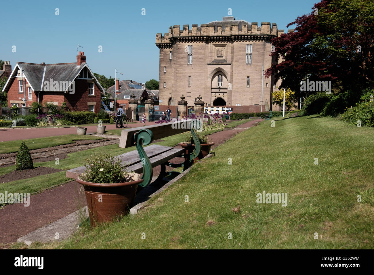 park bench in carlisle park morpeth uk with the old court house in the ...